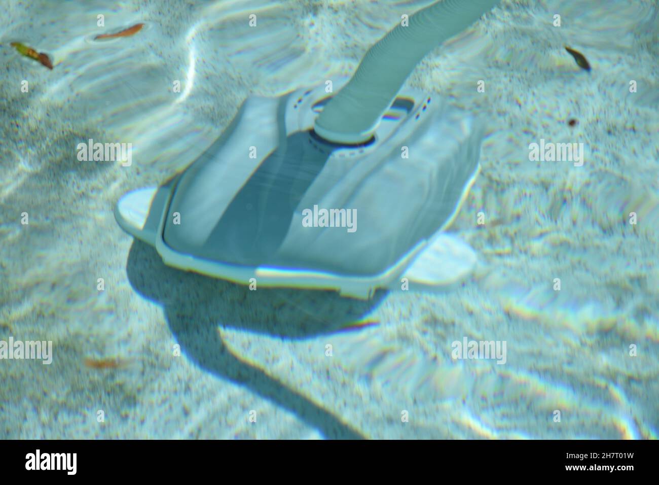 A vaccuum scours the bottom of a swimming pool Stock Photo - Alamy