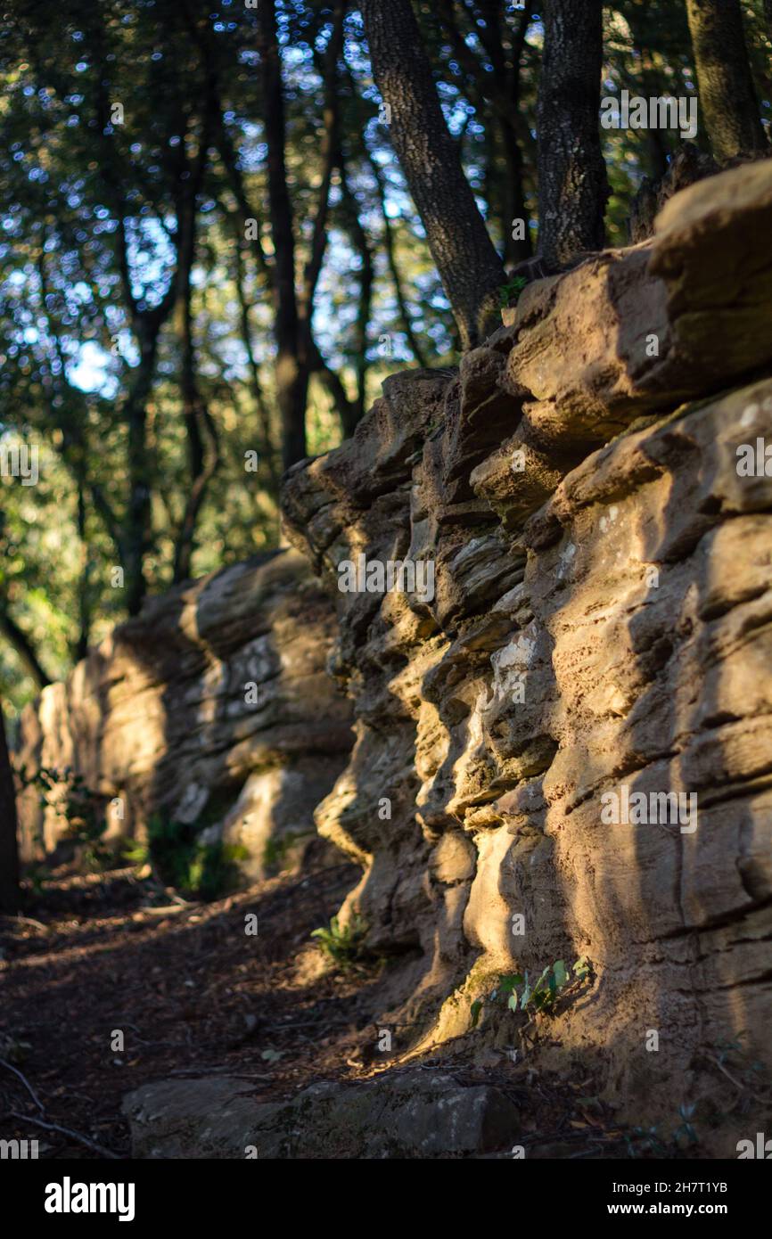 Pathway surrounded by rocky walls in the park Stock Photo - Alamy