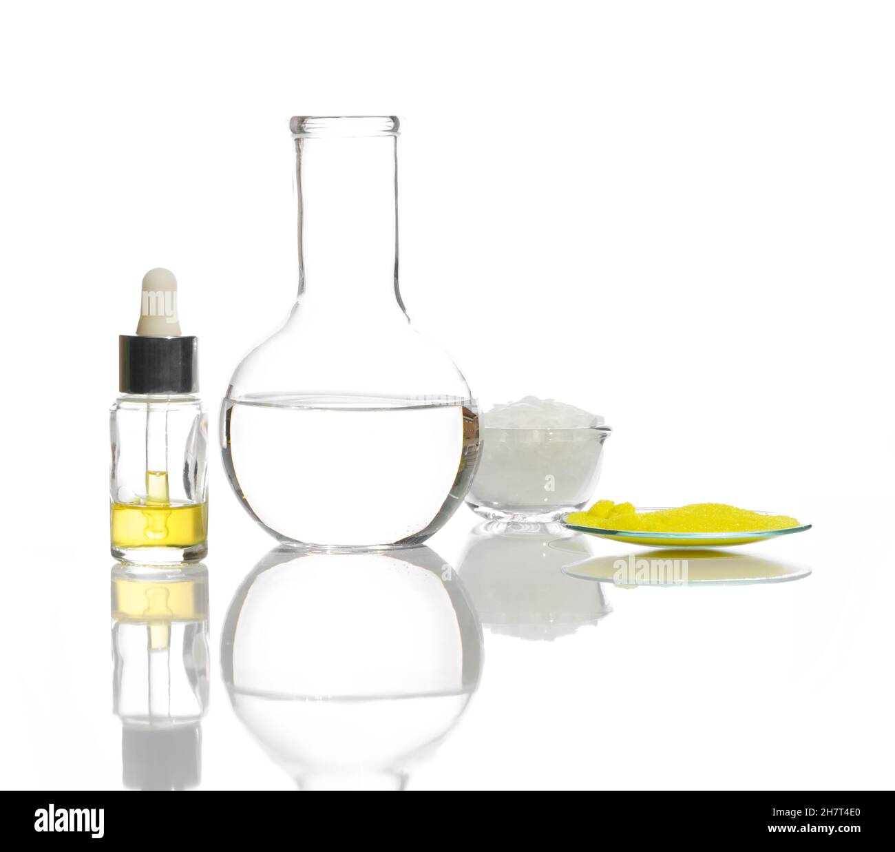 Closeup chemical ingredient on white laboratory table. Yellow cosmetic ...