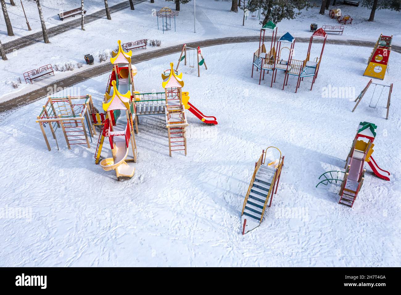 frozen colorful playground under snow in winter park at sunny winter ...