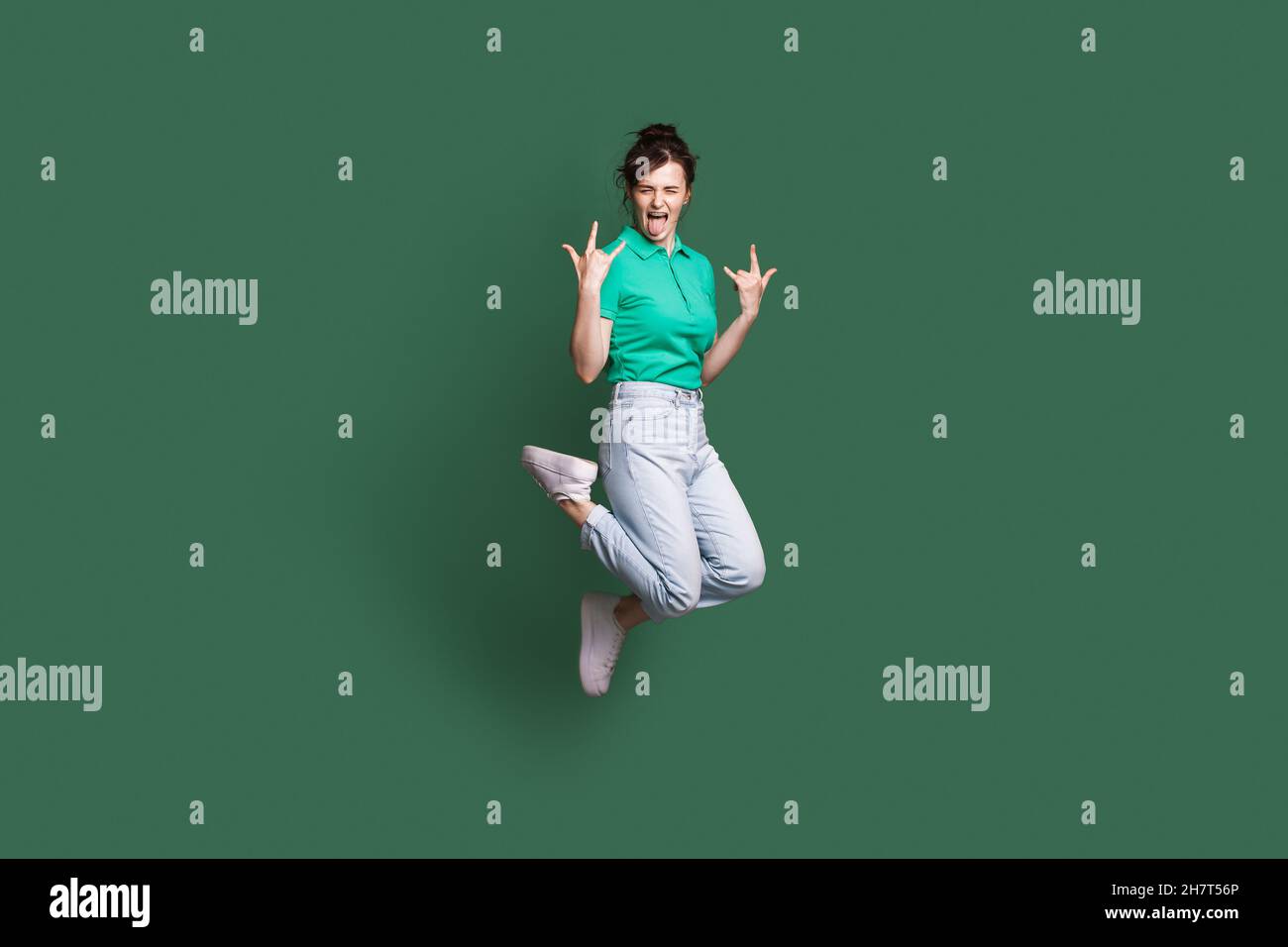 Full size photo of young crazy caucasian woman jumping showing tongue ...