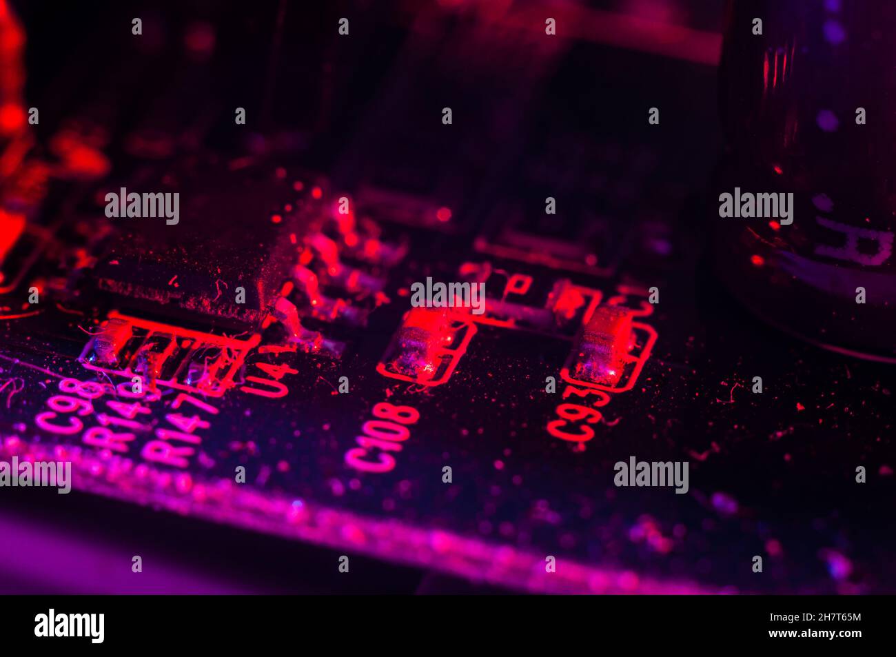 Close-up of an electronic circuit board covered with dust in a macro ...
