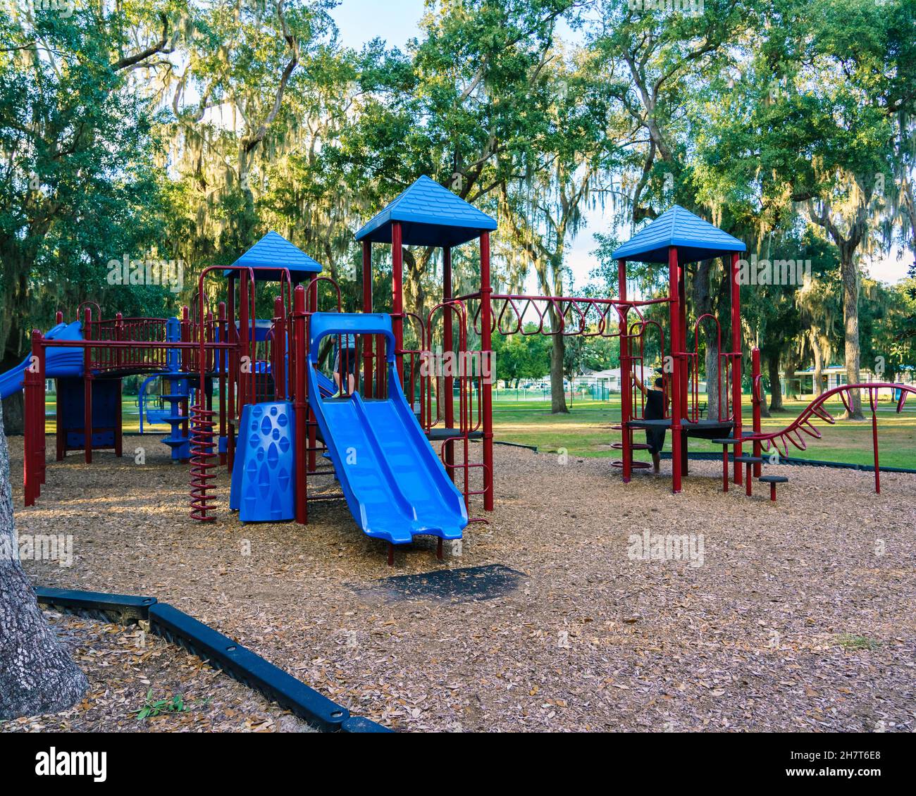 Red and blue children's playground in a park Stock Photo - Alamy