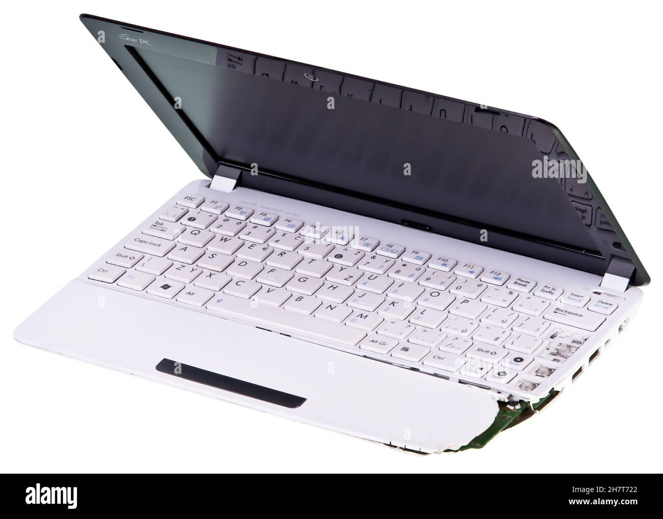 Closeup of a black and white laptop with broken base panel isolated on ...