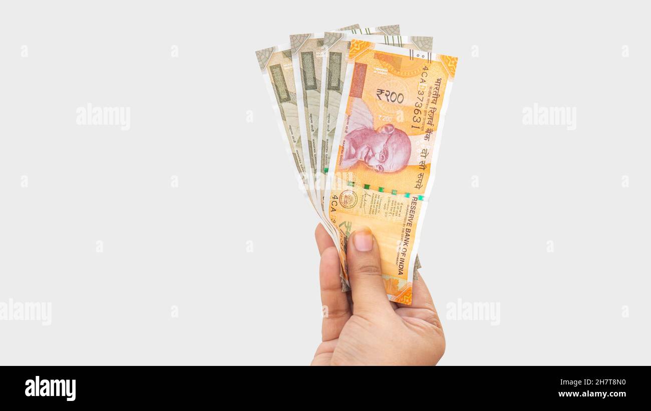 Hand holding a Indian rupee isolated on a white background Stock Photo ...