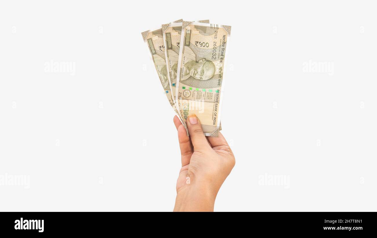 Hand holding a Indian rupee isolated on a white background Stock Photo ...
