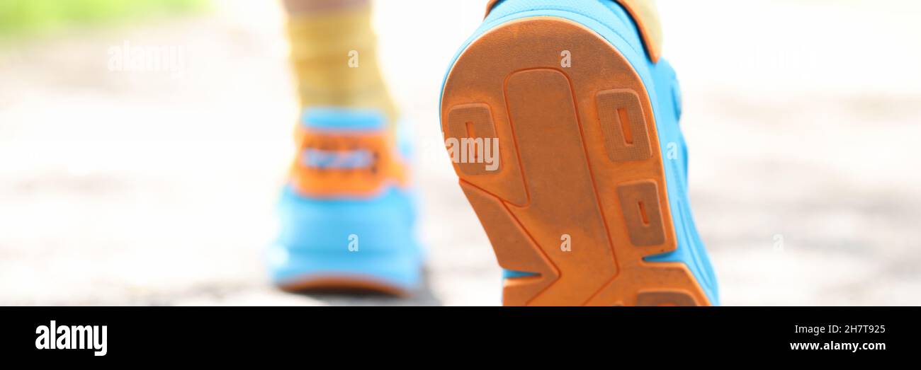 Leg of man taking step in sports sneakers closeup Stock Photo - Alamy