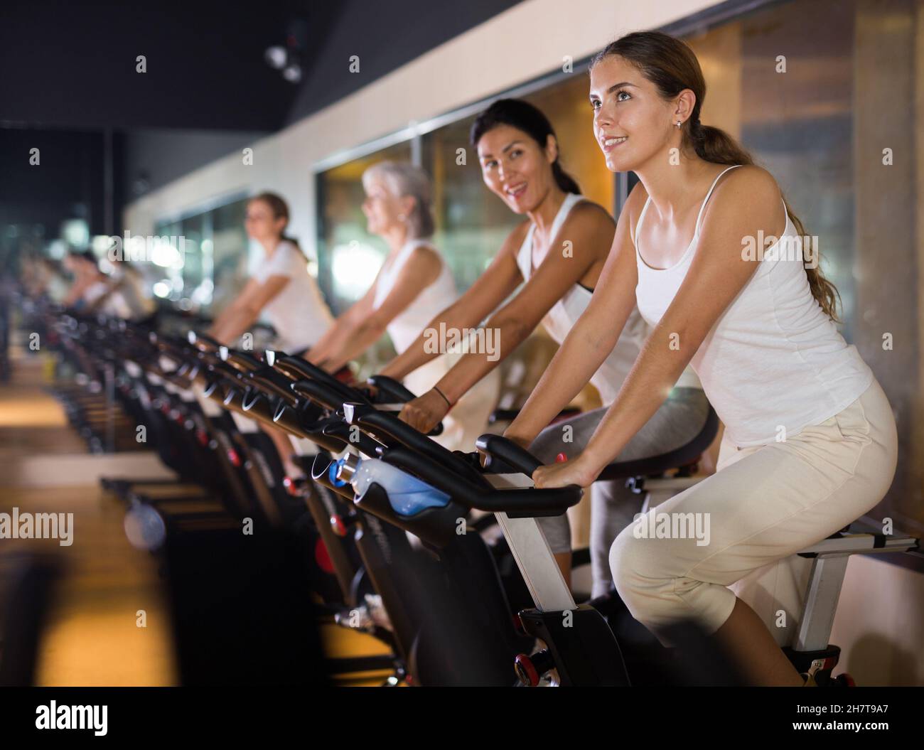 Woman taking indoor cycling class at gym Stock Photo - Alamy