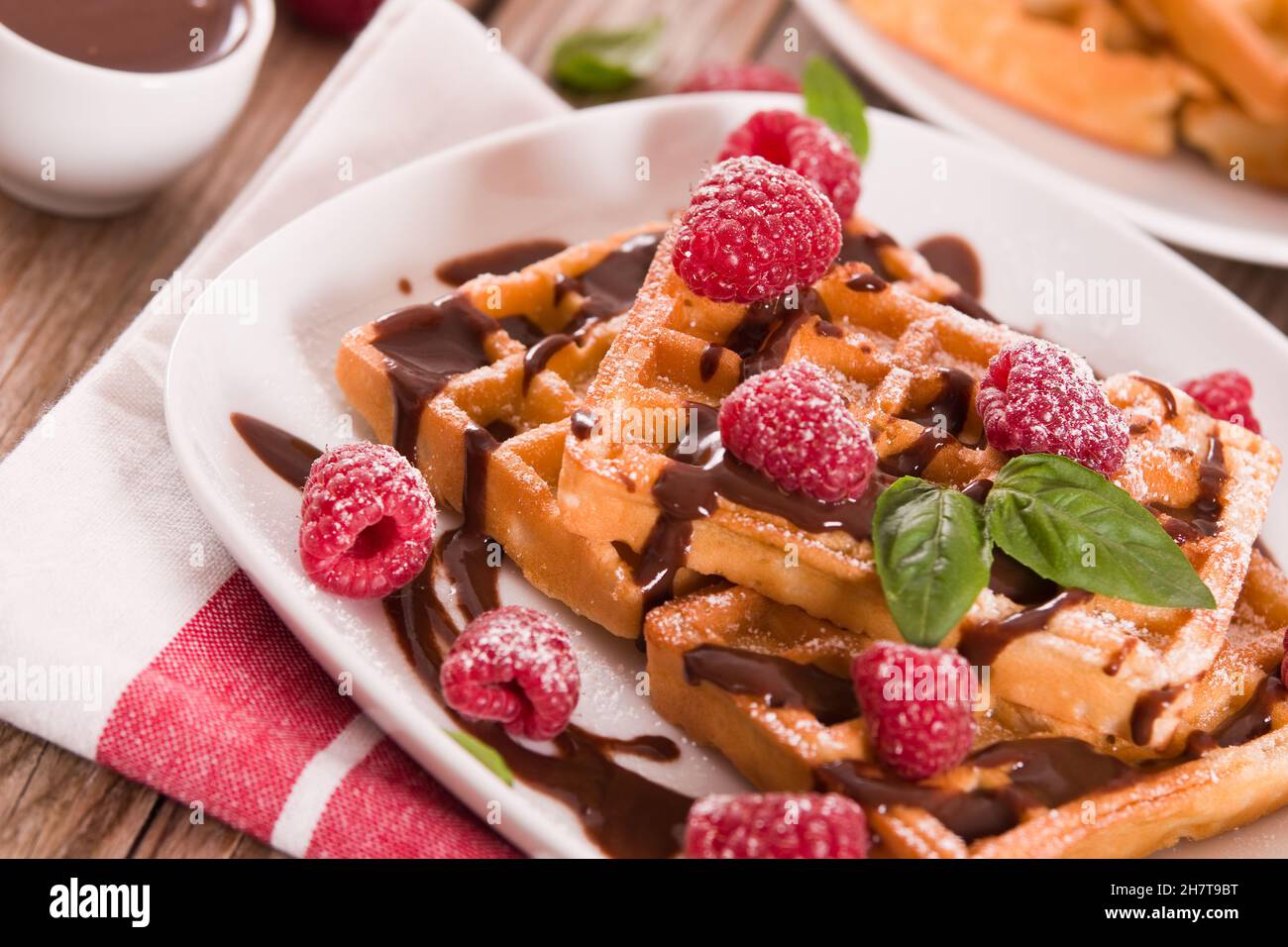 Waffles with raspberries and chocolate cream Stock Photo - Alamy