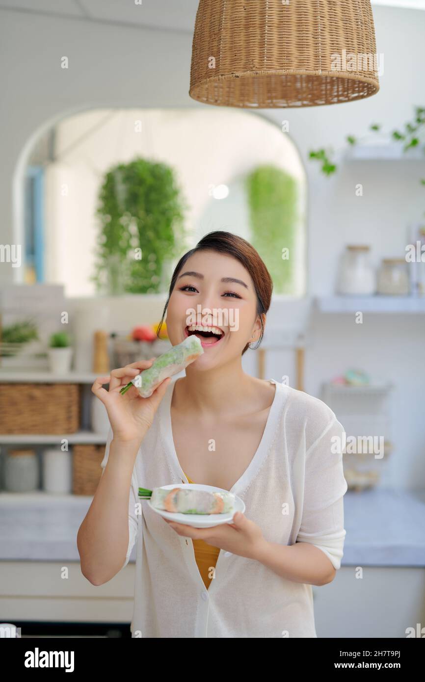 woman eating healthy spring roll Stock Photo - Alamy