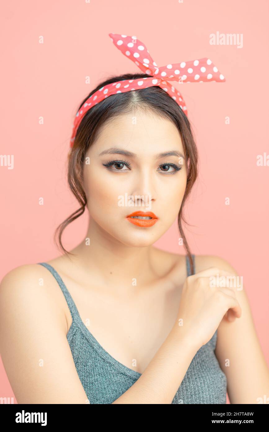 Beautiful thinking girl posing on pink background Stock Photo - Alamy