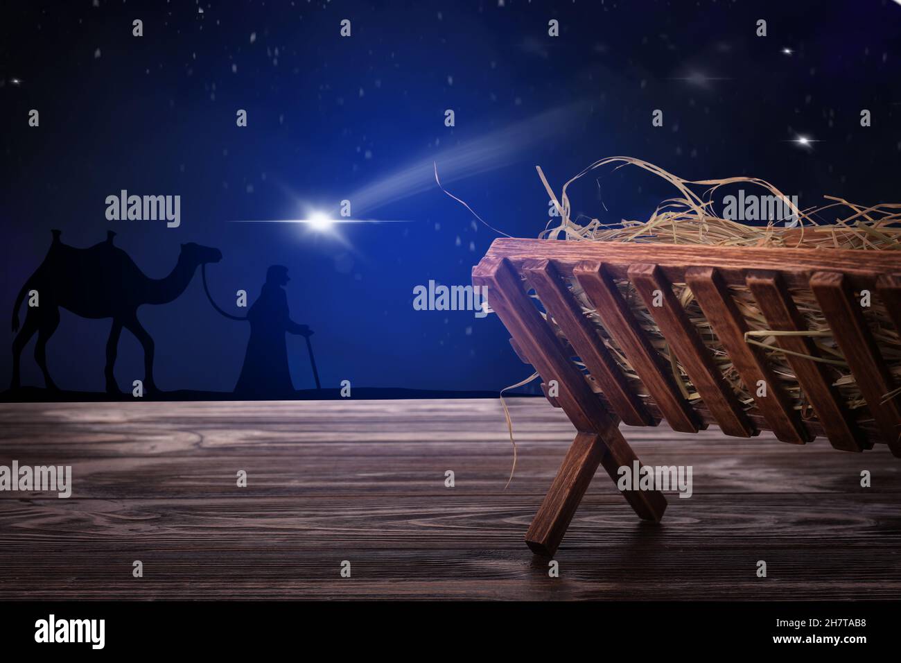 Wooden manger with hay on table at night. Concept of Christmas story ...