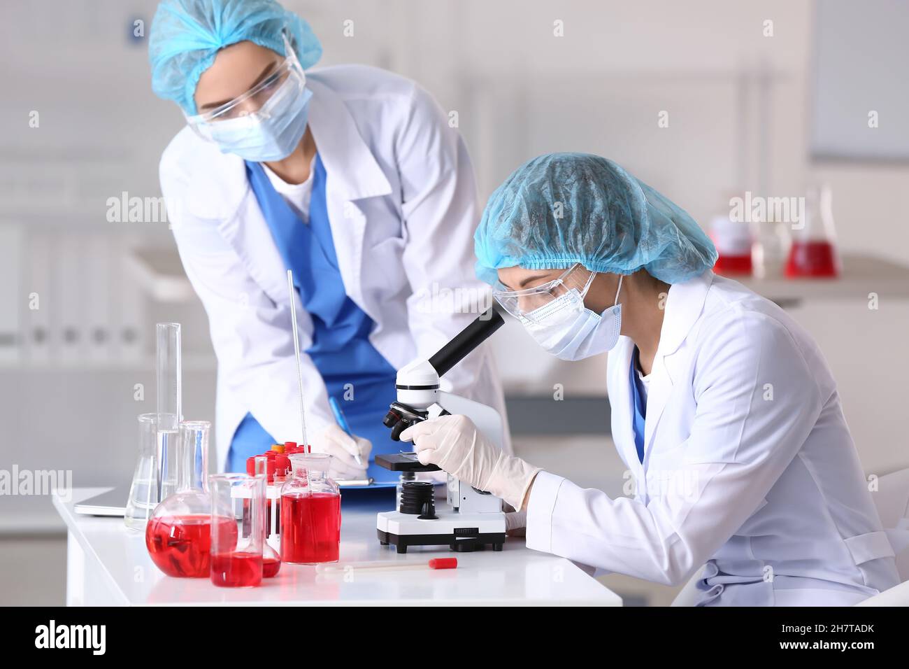 Scientists studying sample in laboratory Stock Photo - Alamy