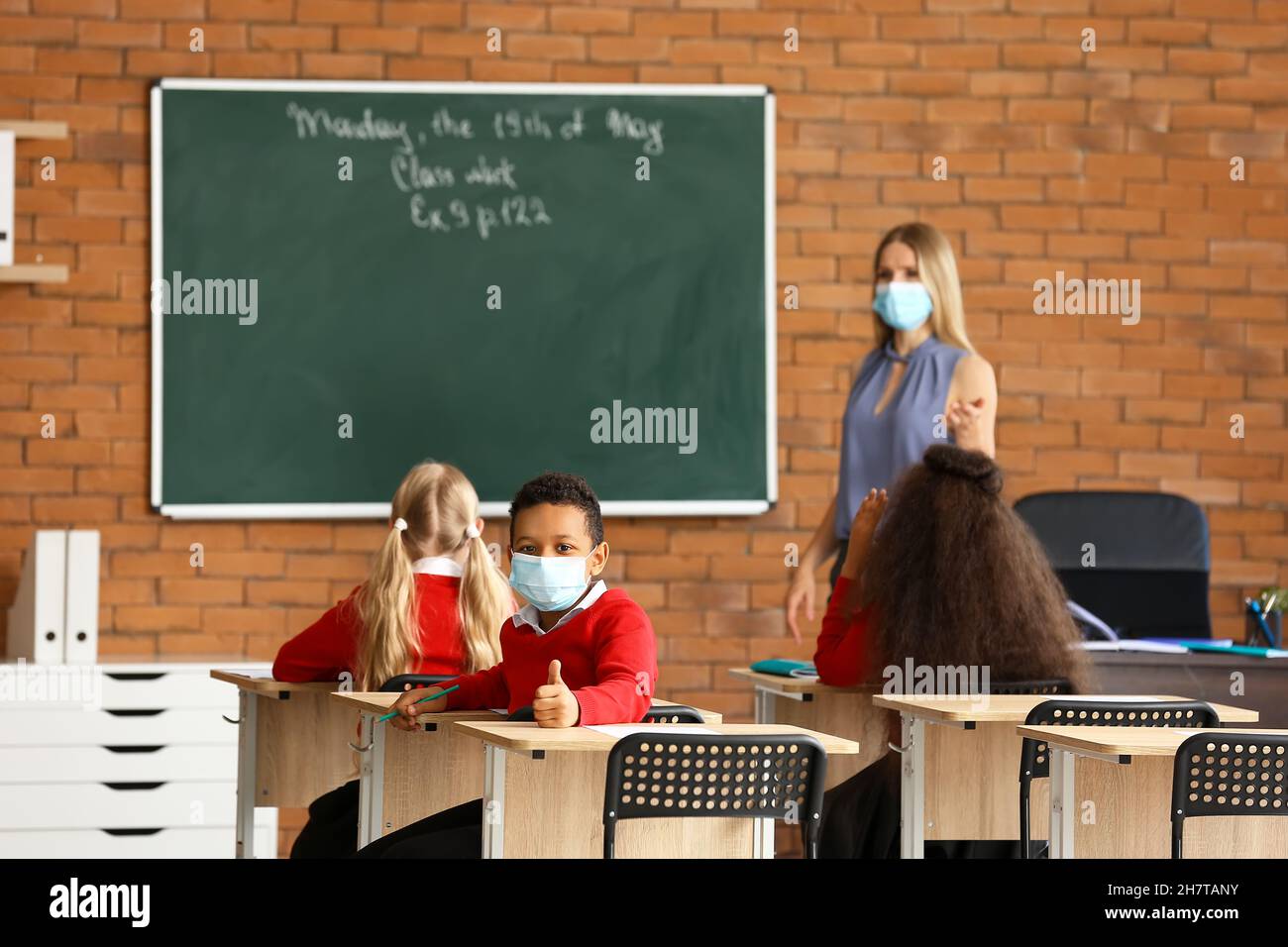 Teacher conducting lesson in classroom Stock Photo - Alamy