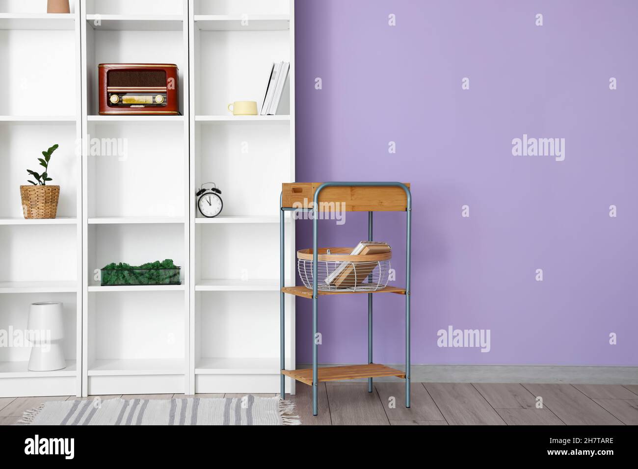 Modern shelf unit and table in room Stock Photo - Alamy