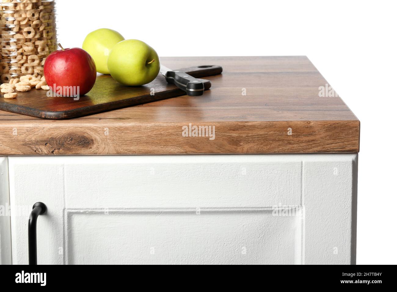 Apples with board and knife on kitchen counter against white background ...