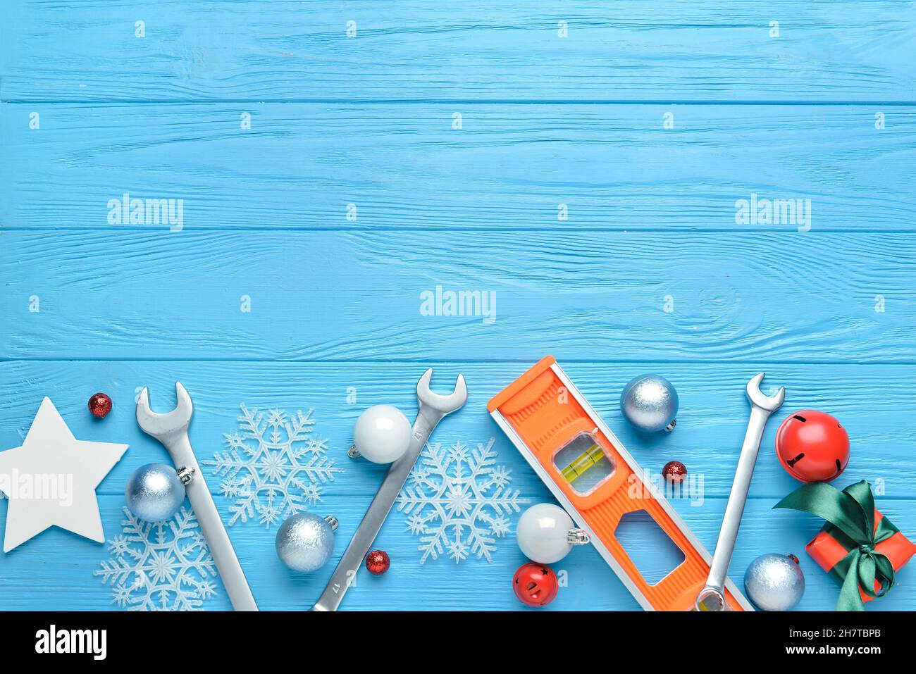 Set of construction tools and Christmas decor on color wooden ...