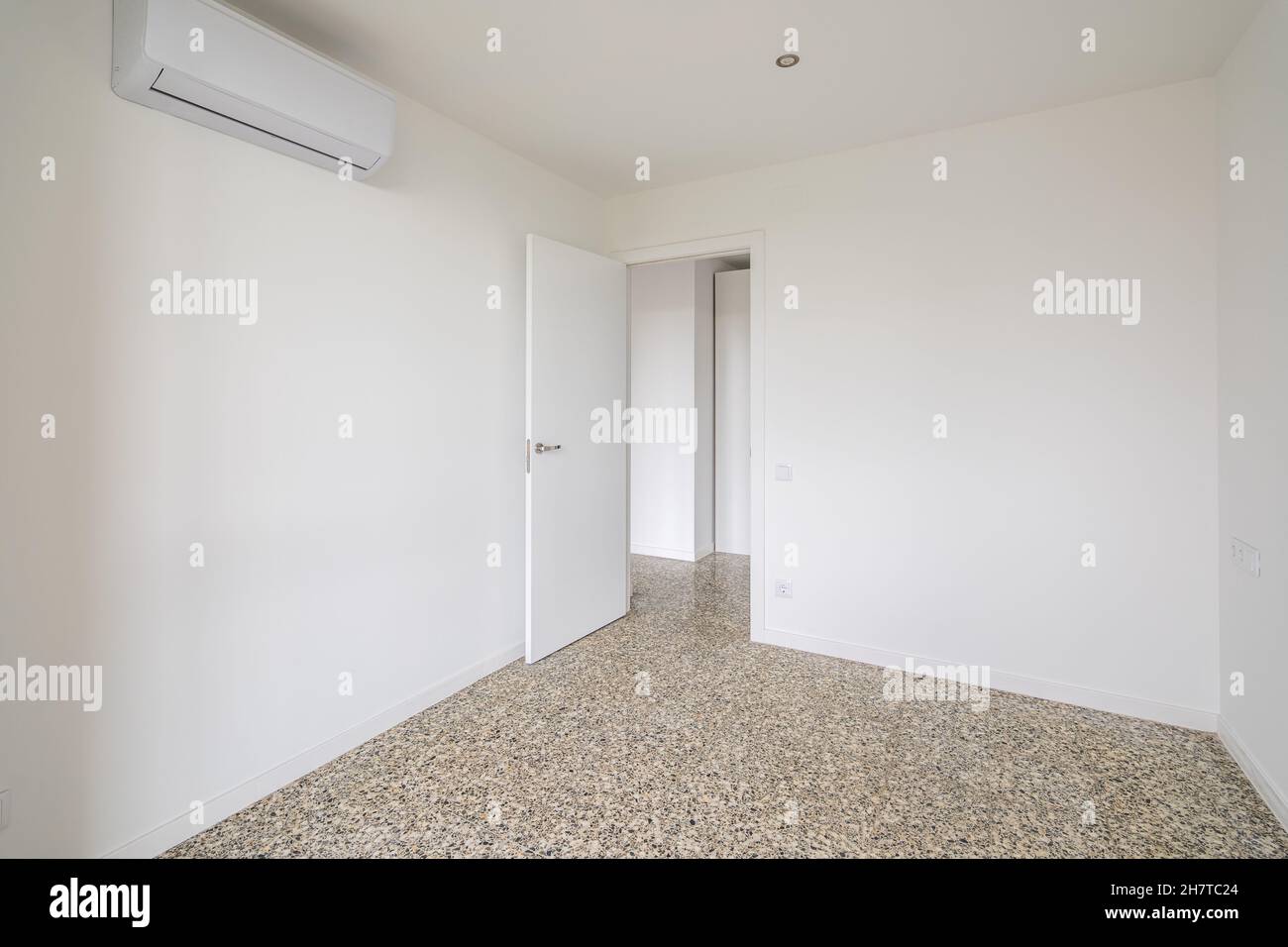 Interior of empty apartment, white room with air conditioning and tiled ...