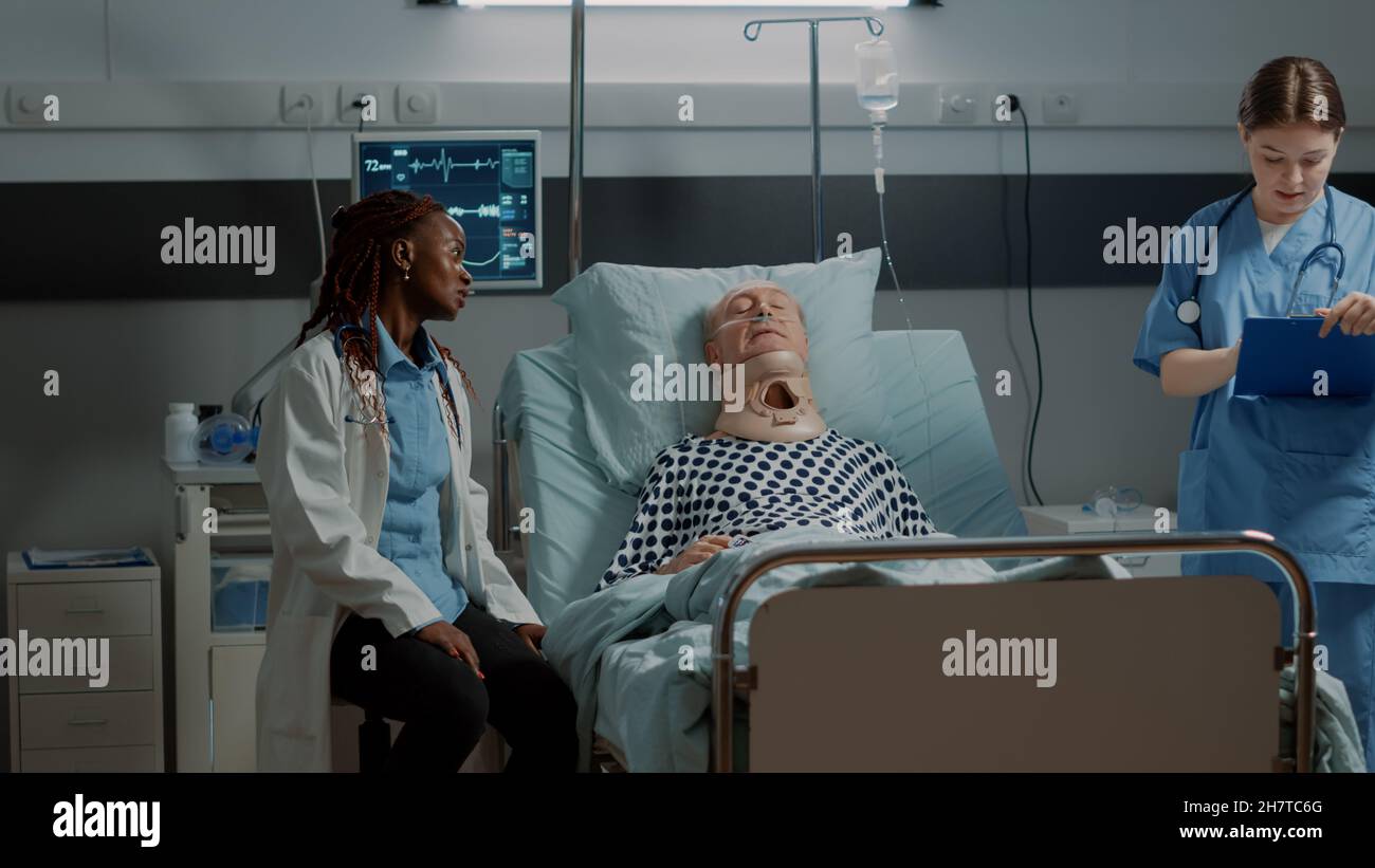 Multi ethnic medical staff checking on patient healthcare in hospital ...