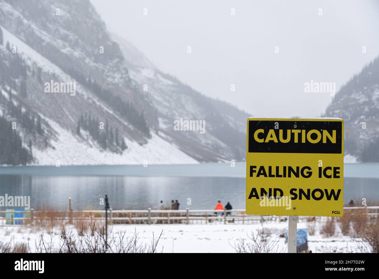 Falling Ice and Snow warning sign in national park during snowfall ...