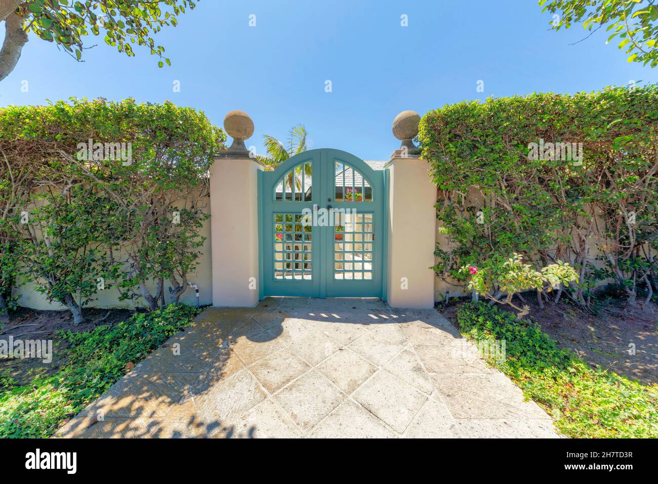 Arched light blue gate with shrubs at the front at La Jolla, California ...