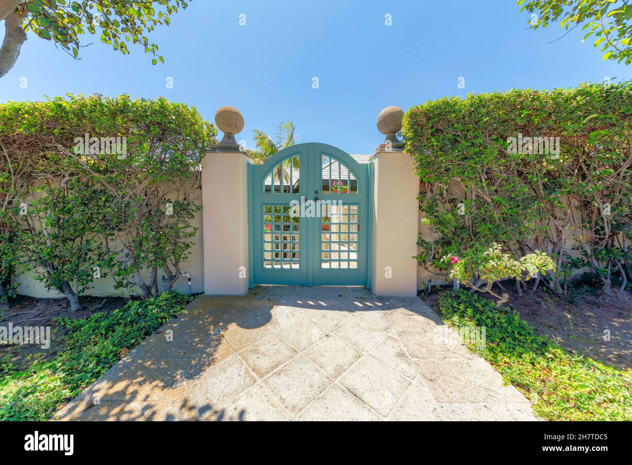 Arched light blue gate with shrubs at the front at La Jolla, California ...