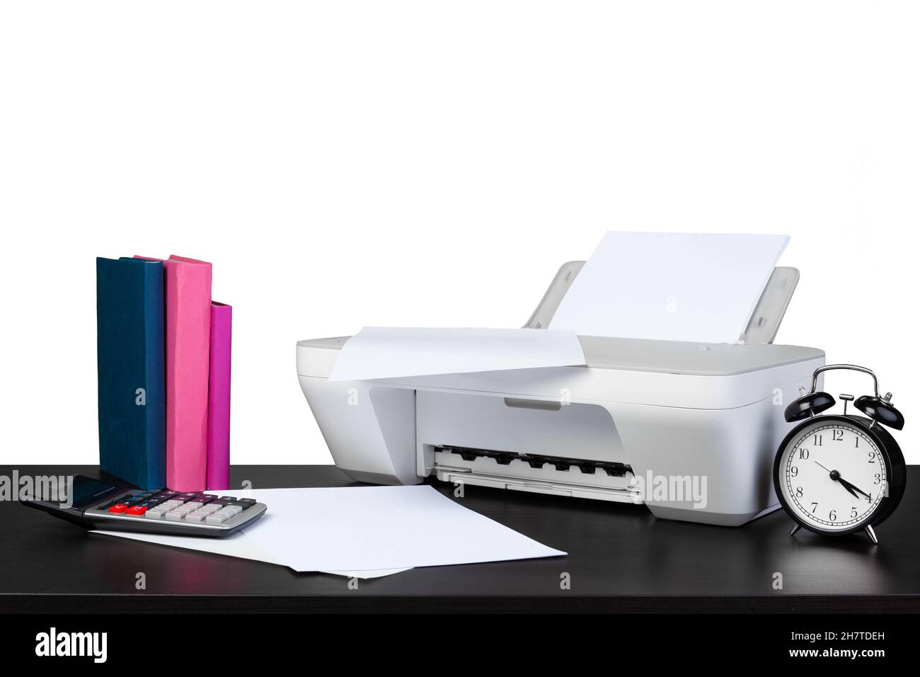 Printer and stack of books on black table against white background ...