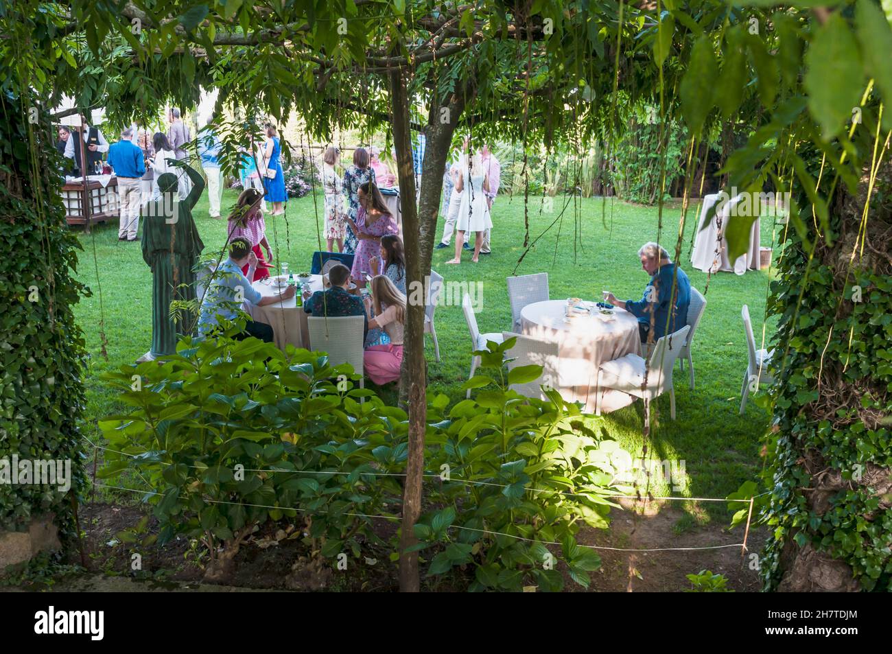 A party in the gardens of Villa Ruffalo, Ravello, Italy, on a warm ...