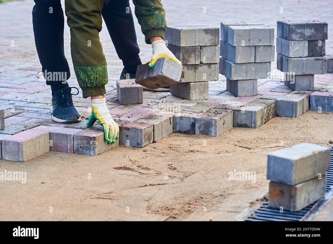 laying paving slabs on the sand with your hands Stock Photo - Alamy
