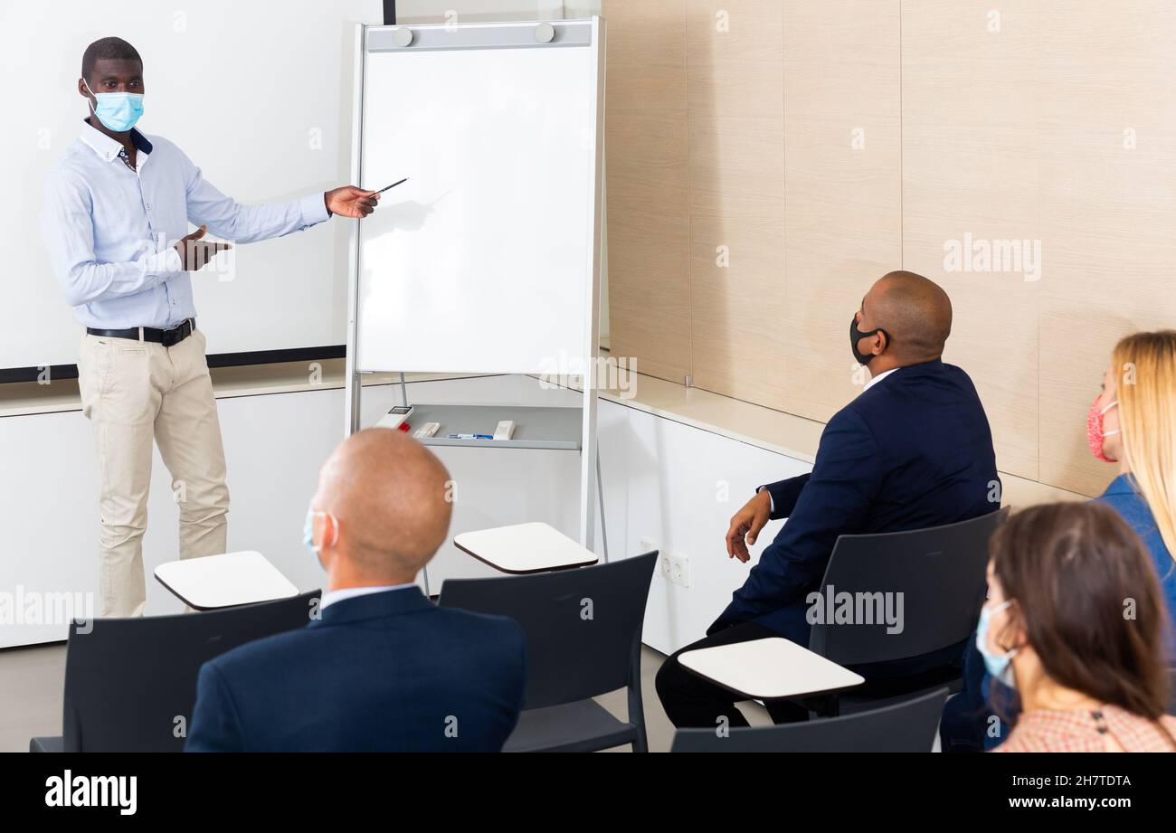 african male instructor explained something to students in meeting room ...