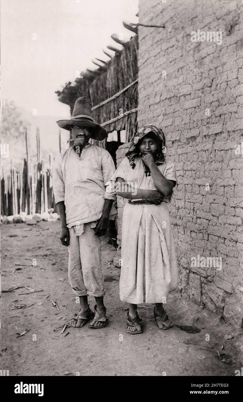 Man and woman standing by wall of building, Mexico - 1880 Stock Photo ...