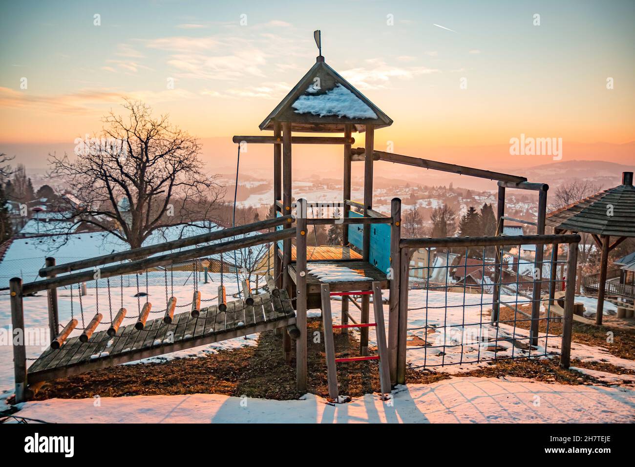 The children's playground is covered with snow and is empty on a cold ...