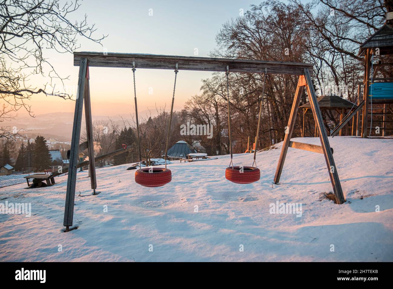 The children's playground is covered with snow and is empty on a cold ...
