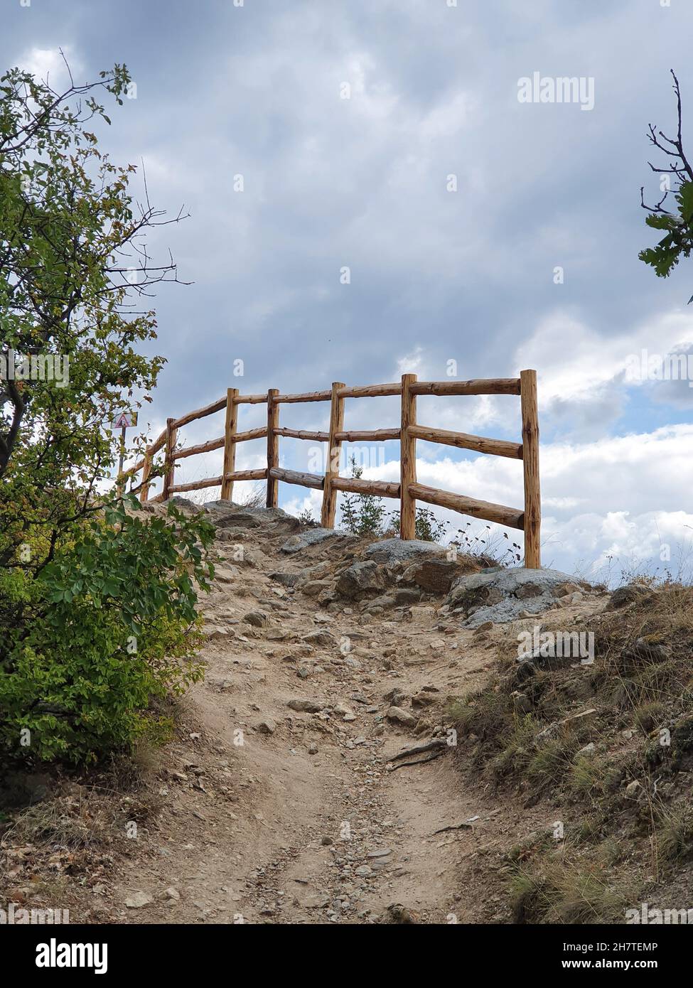 Trail with a wooden railing, footpath, country road, alley, lane in ...