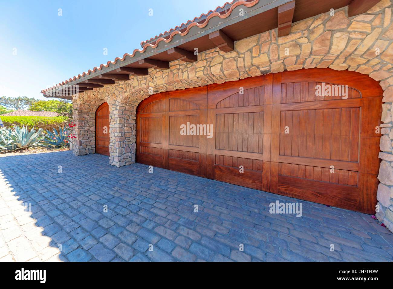 Three-car garage exterior with craftsman mediterranean design at La ...