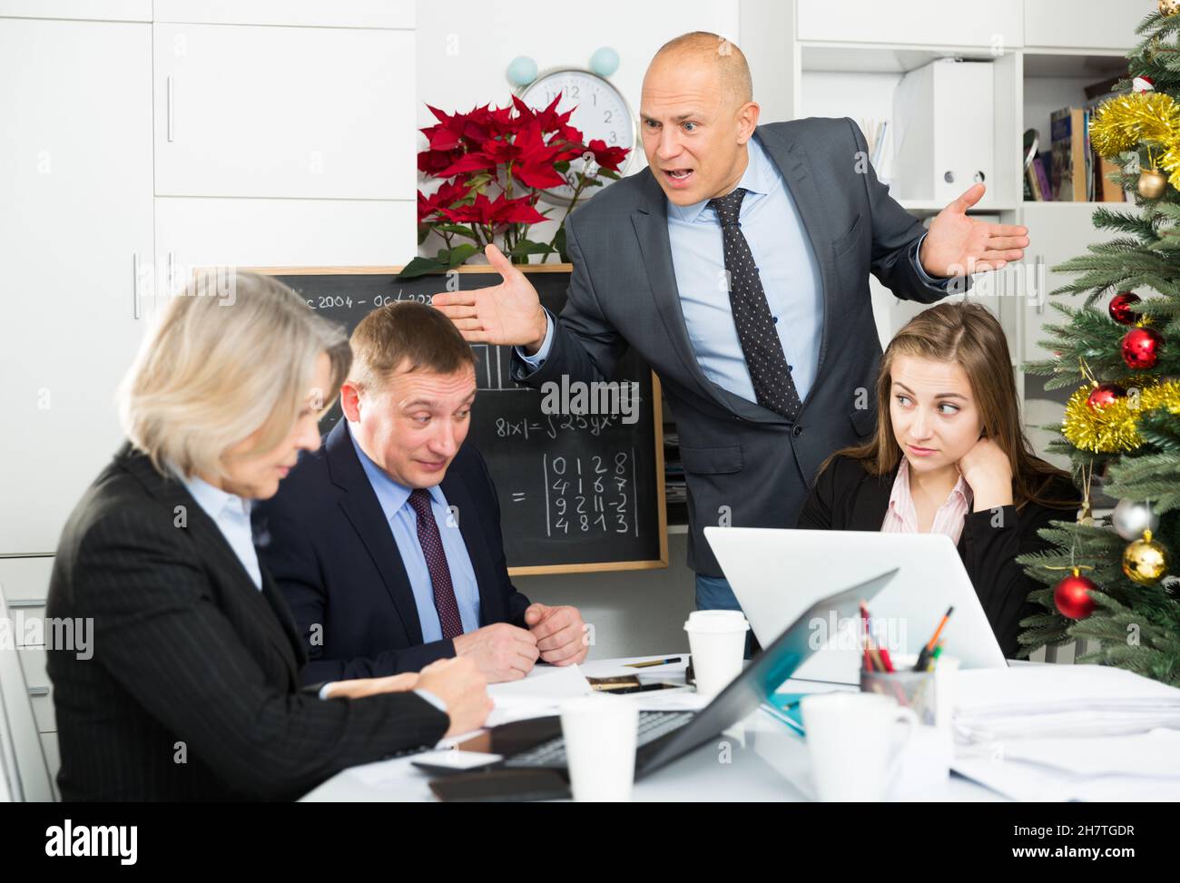 Irritated boss scolding group of stressed managers for incompetence at ...