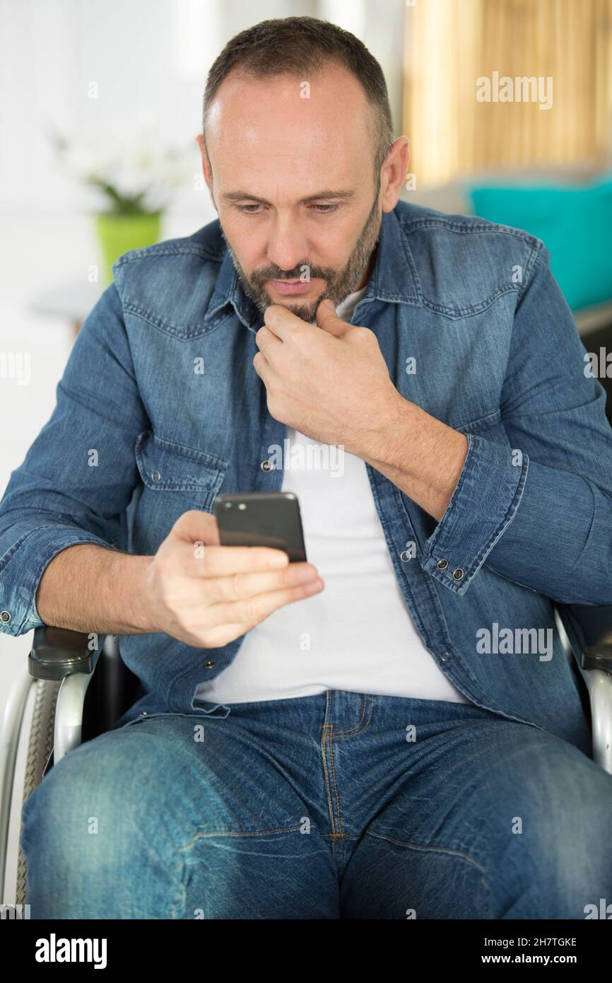 disabled person has serious text conversation Stock Photo - Alamy