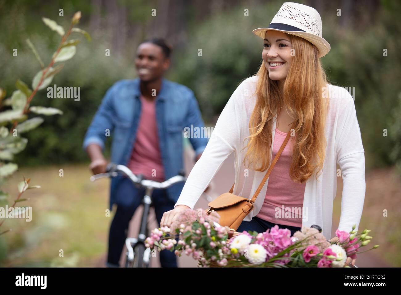 two mountain bikers riding bike in the forest Stock Photo - Alamy