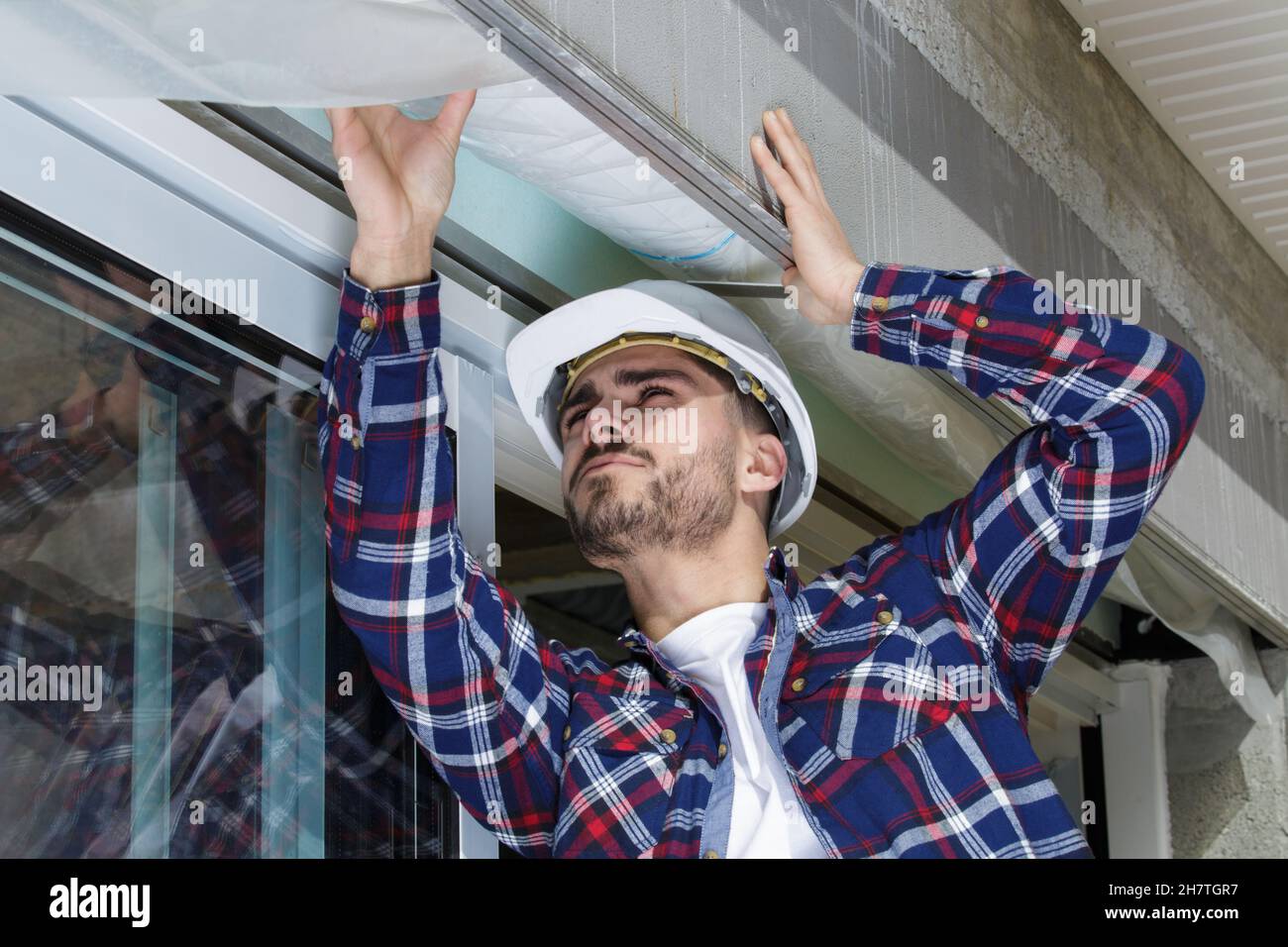 construction worker installing window in house Stock Photo - Alamy