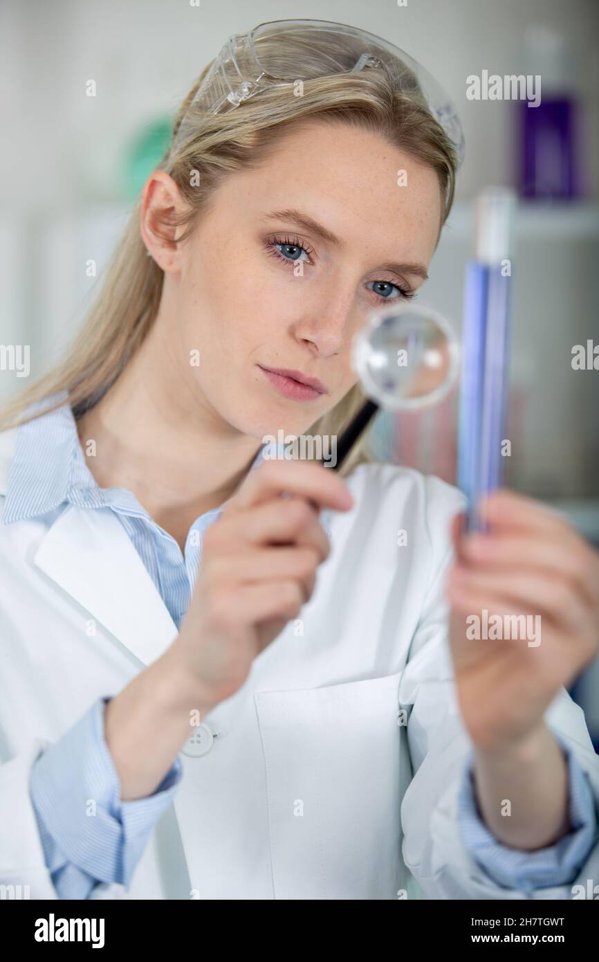 lab assistant with a magnifying glass Stock Photo - Alamy