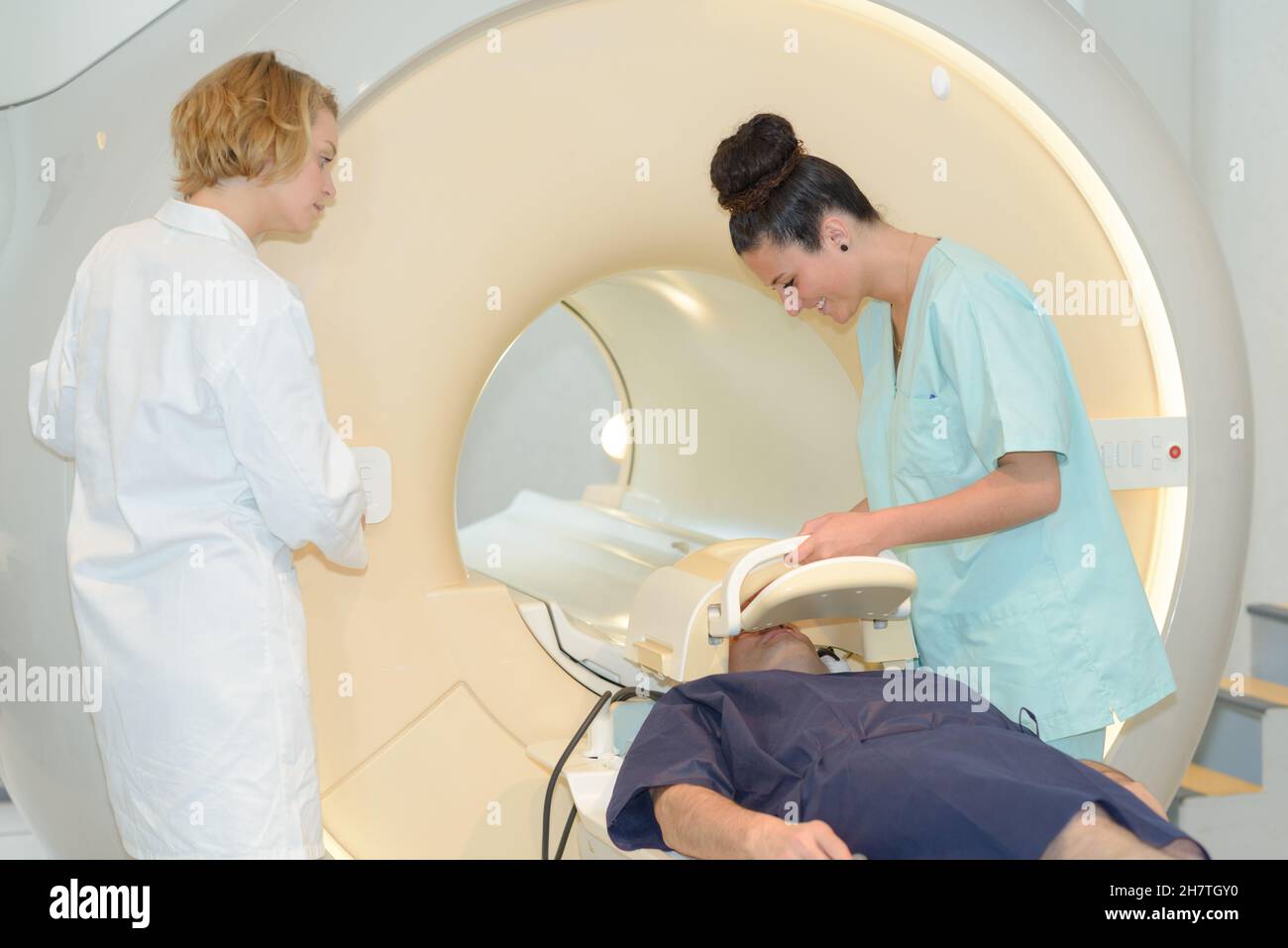 doctor with colleague preparing patient for ct scan Stock Photo - Alamy
