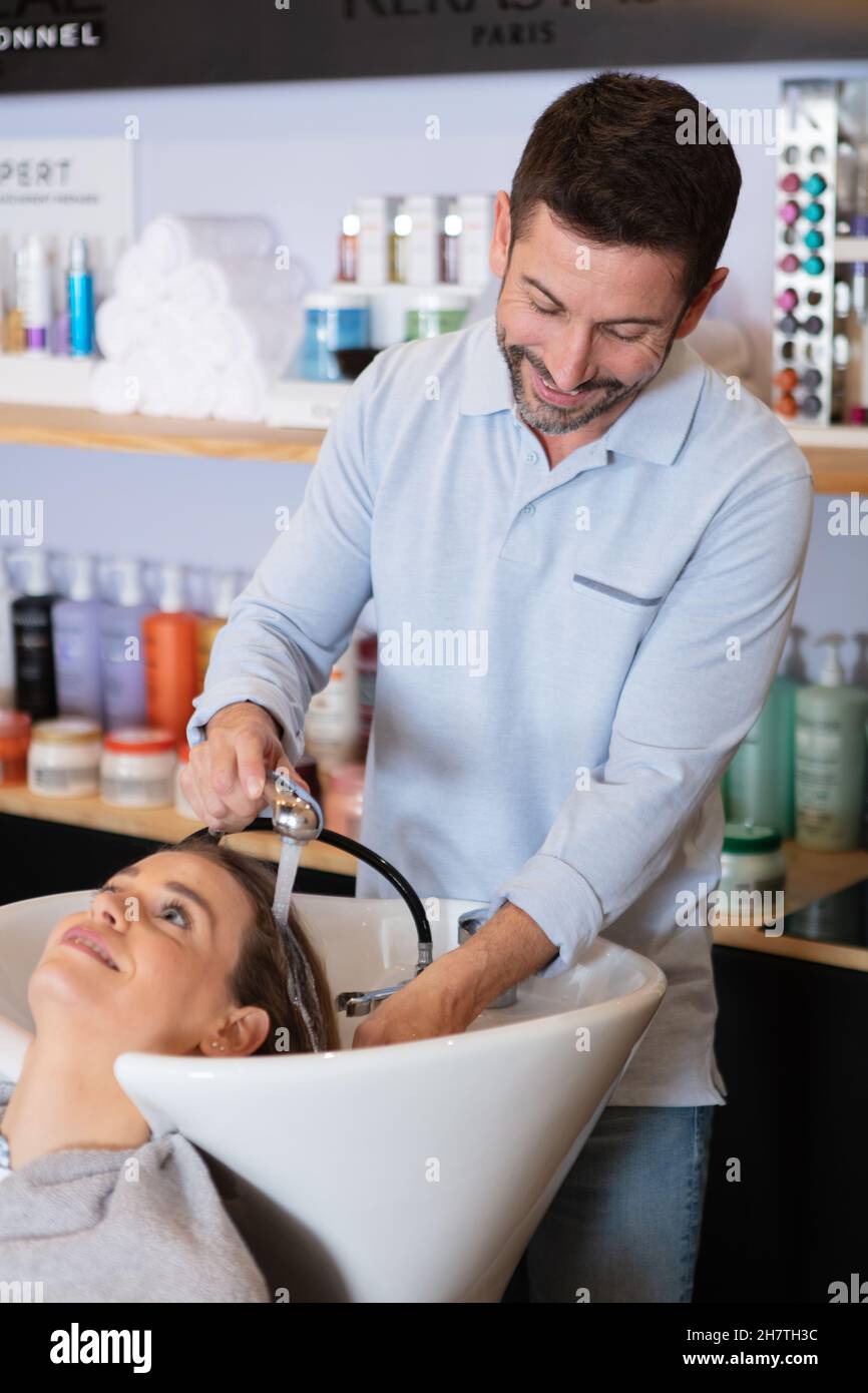 Smiling hispanic woman washing hi-res stock photography and images - Alamy