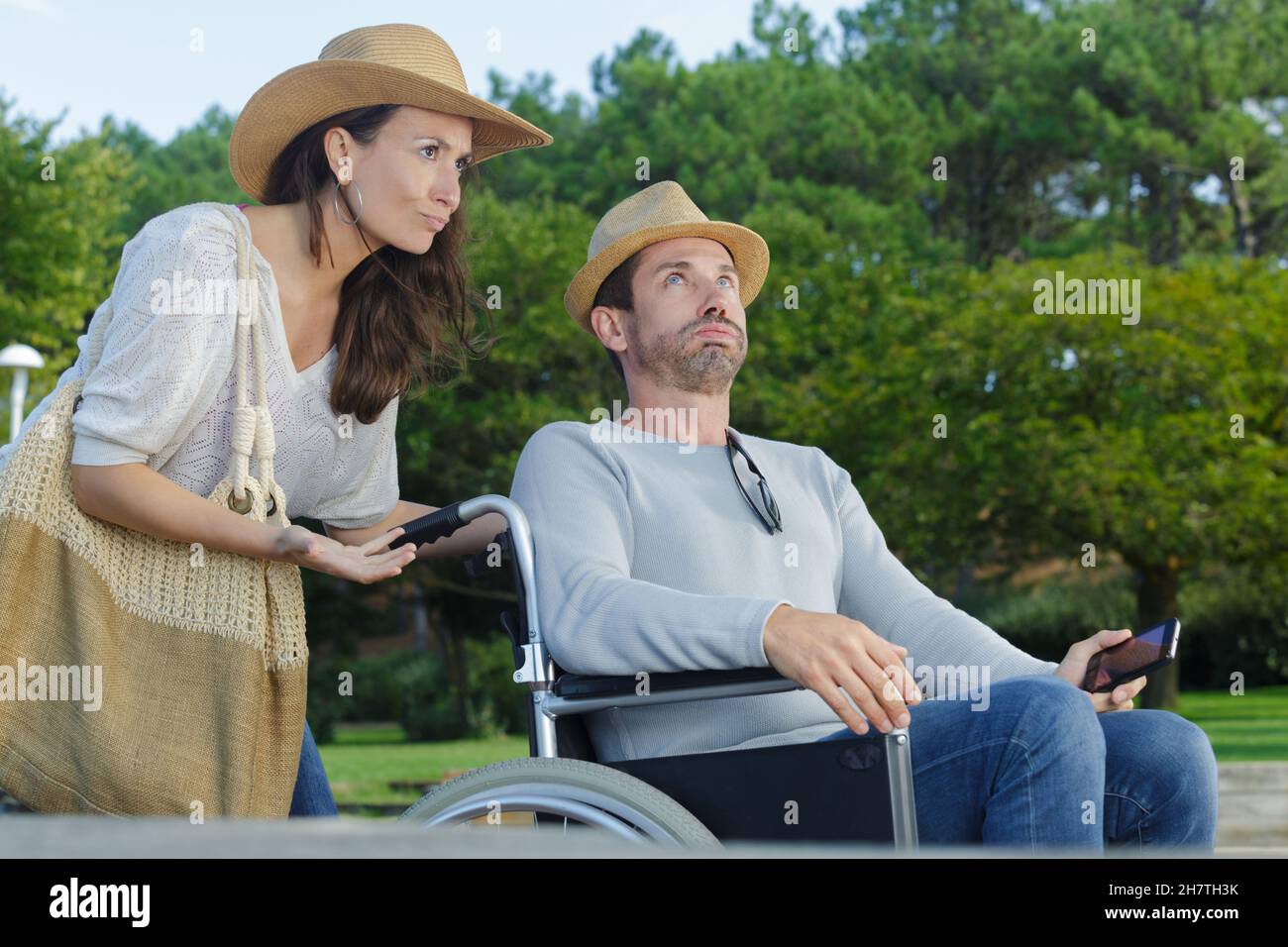 expressive couple on walk in park man in wheelchair Stock Photo - Alamy