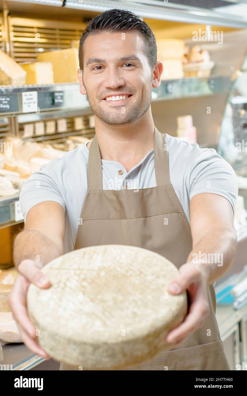 a man is showing cheese Stock Photo - Alamy