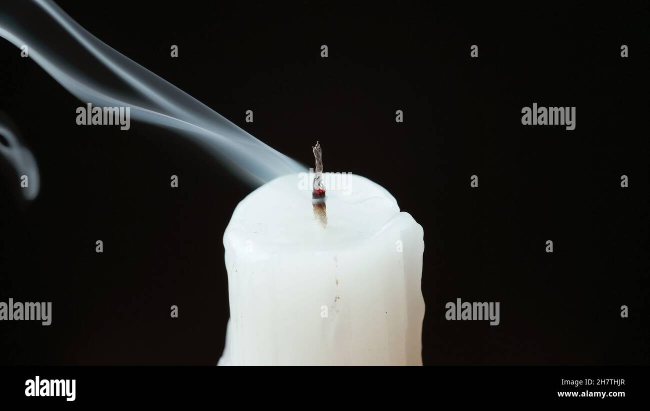 Photo of the smouldering white candle and smoke Stock Photo - Alamy