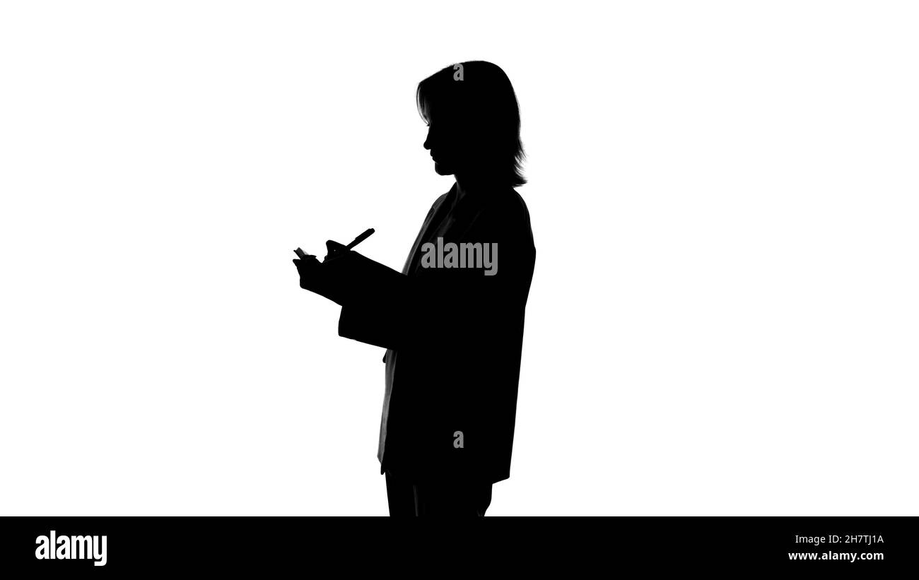 Photo of woman's silhouette takes notes on isolated white background ...