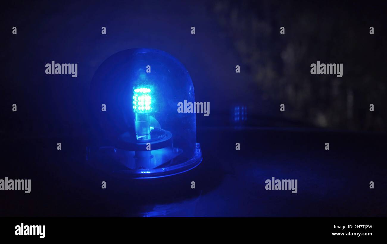 Shooting of rotating blue emergency light in the night Stock Photo - Alamy