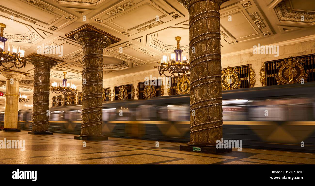 Long exposure of subway train moving in old fashioned station with ...