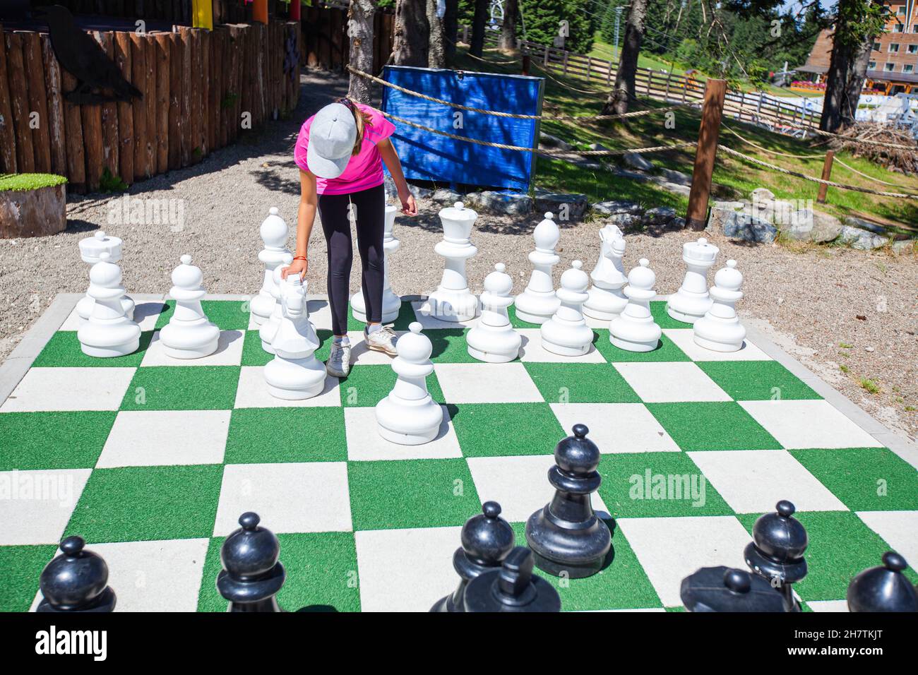 Child playing giant outdoor chess set in park Stock Photo - Alamy