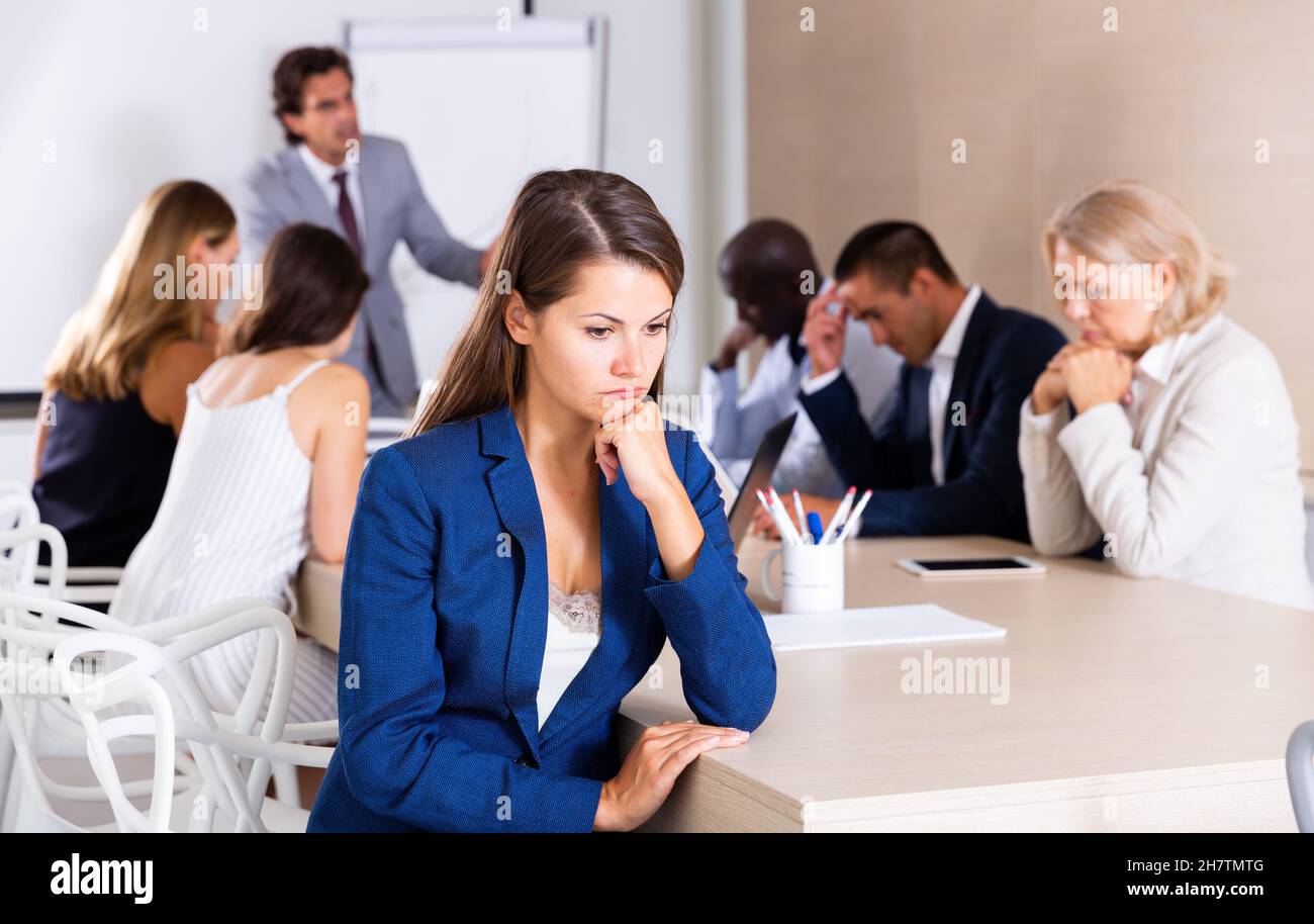 Sad and tired business woman on meeting Stock Photo - Alamy
